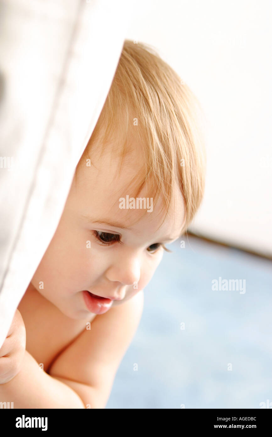 baby boy hiding behind mother s leg Stock Photo - Alamy