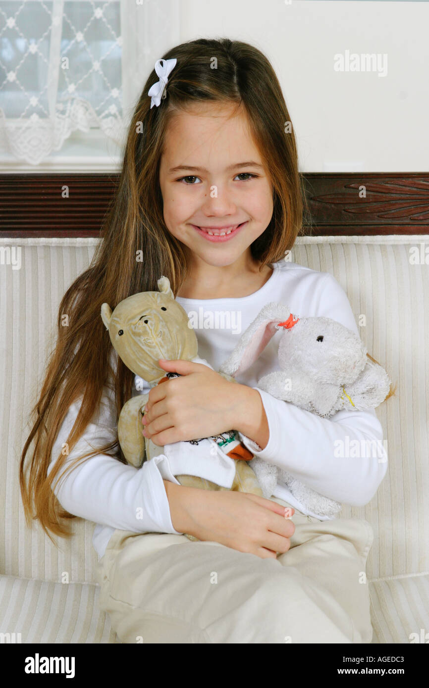 young girl cuddling her stuffed animals Stock Photo - Alamy