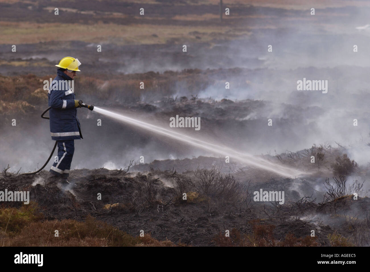 Fireman firefighter battles to control a fire on moorland in the Brecon ...