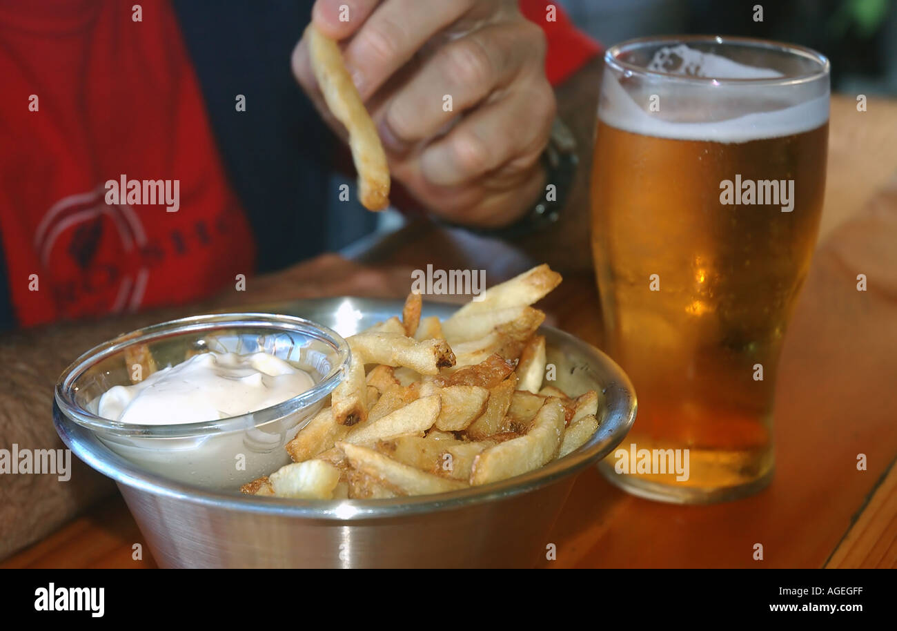 Overweight man eating chips hi-res stock photography and images - Alamy