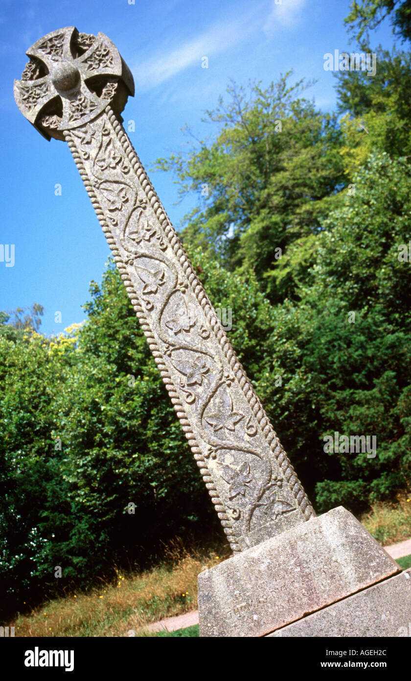 Tall stone commemorative cross with celtic carving design of ivy and ...