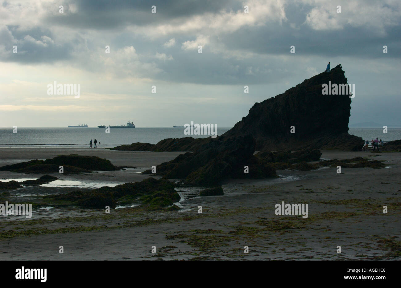 Sun setting behind the rock formations of Broad Haven beach ...