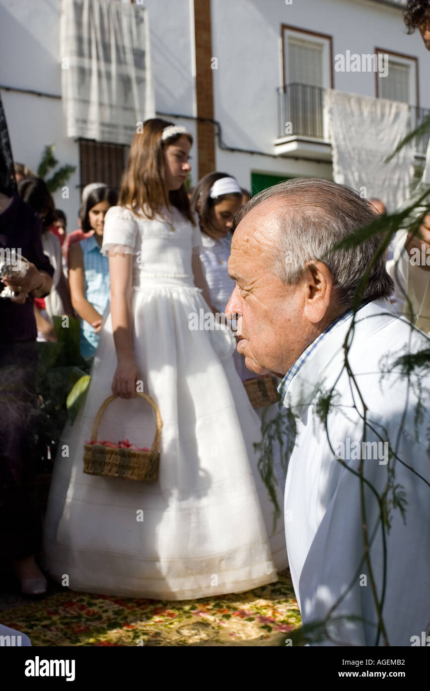 kneeling sacristan and child in frist communion dress Corpus Christi ...