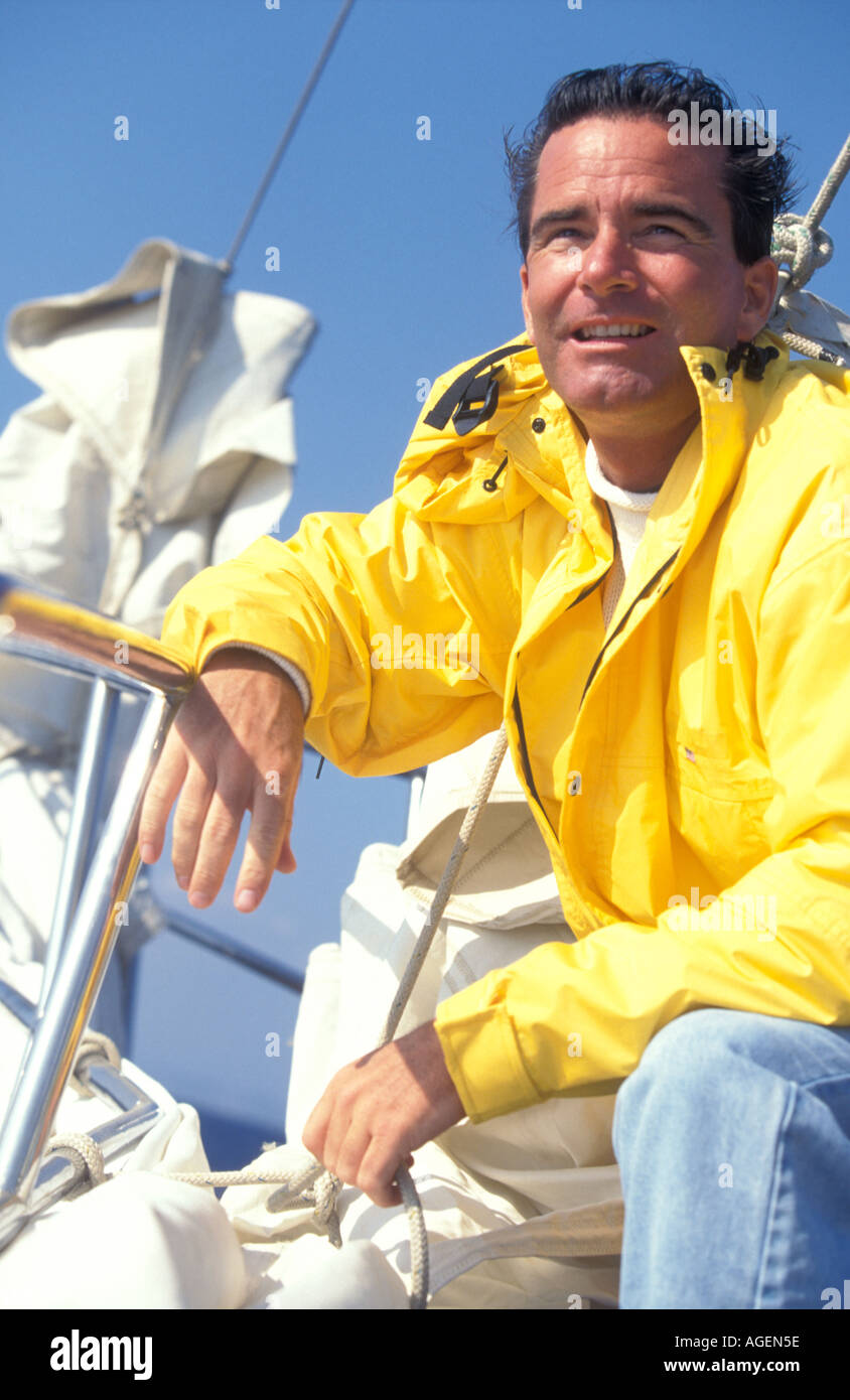 man with yellow rain jacket on sailing ship Stock Photo - Alamy