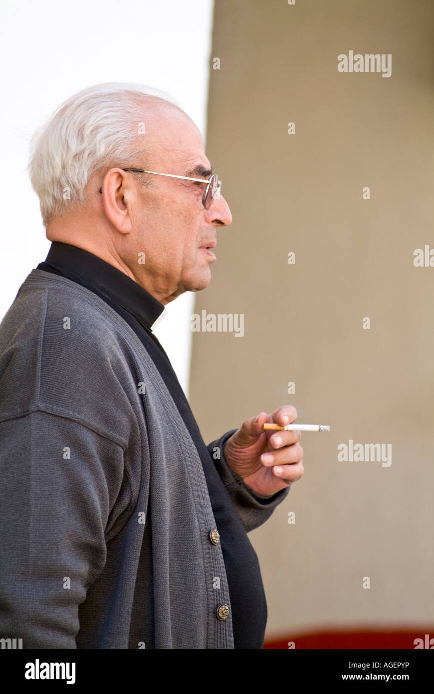 priest smoking a cigaret Stock Photo - Alamy