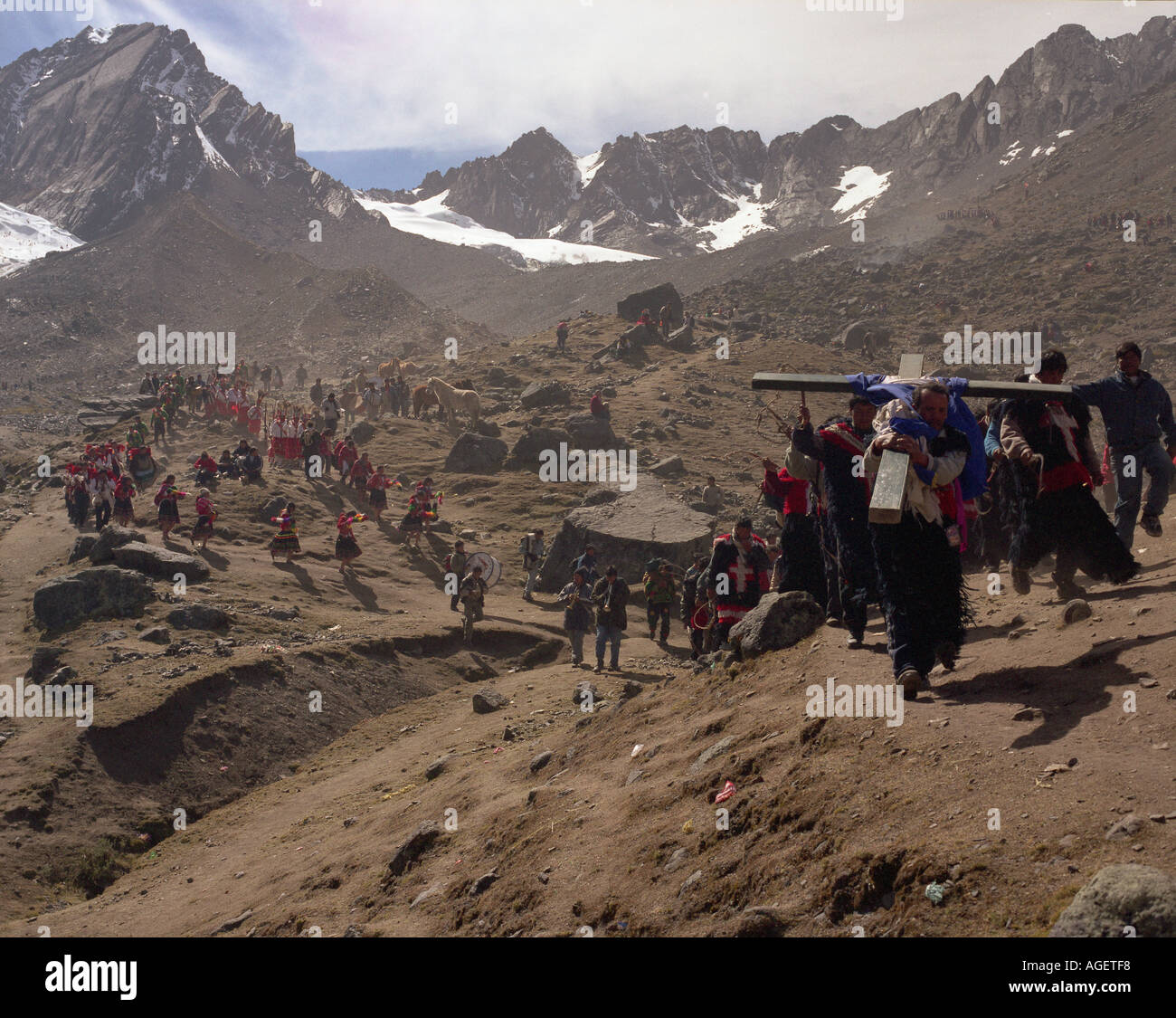 Religious festival in the Andes with indigenous people carrying a cross ...