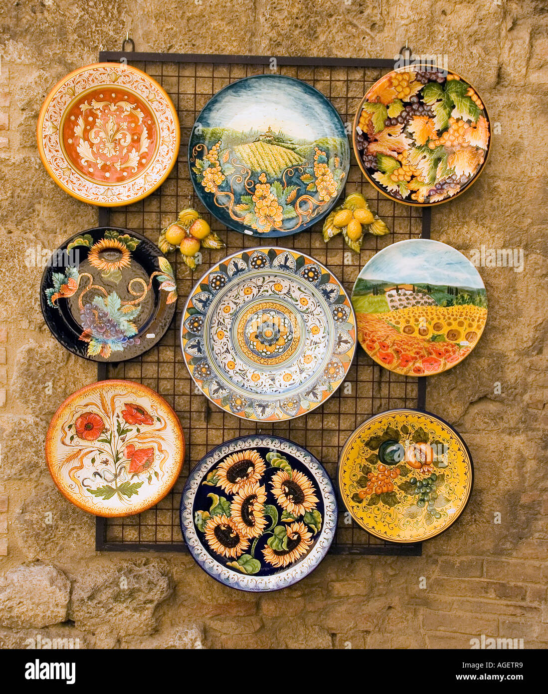 Colourful Ceramic Plates on display outside a retailer in San Gimignano ...