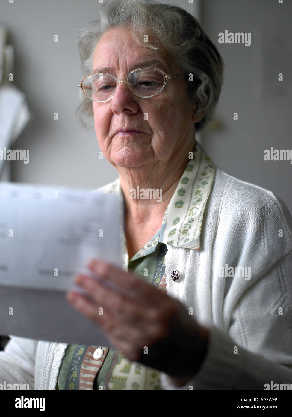 mature women reading letter or bill Stock Photo - Alamy
