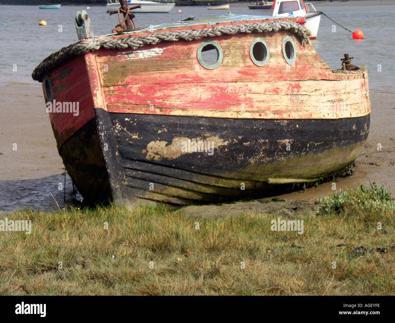 Old red and black boat decaying in mud Orford Suffolk England Stock ...