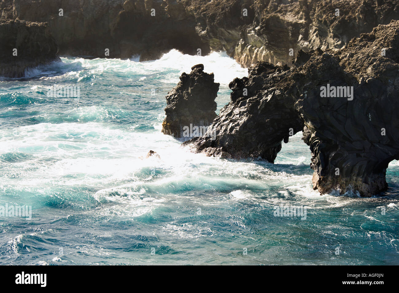 Water from the Pacific ocean coming into rocky beach alcove in Maui ...