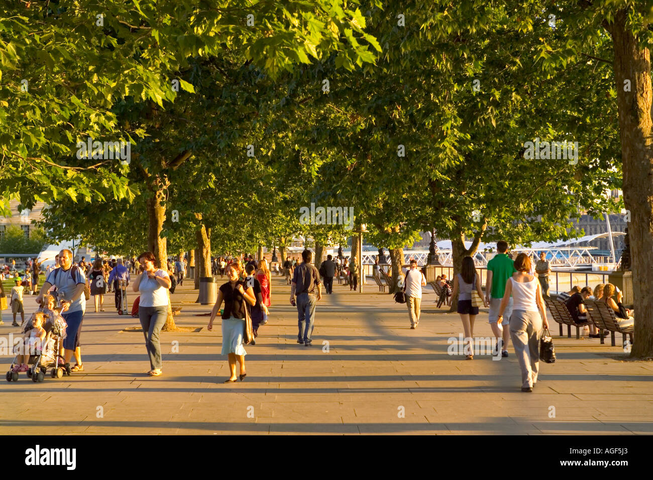 People walking alomg the embankment London Stock Photo - Alamy