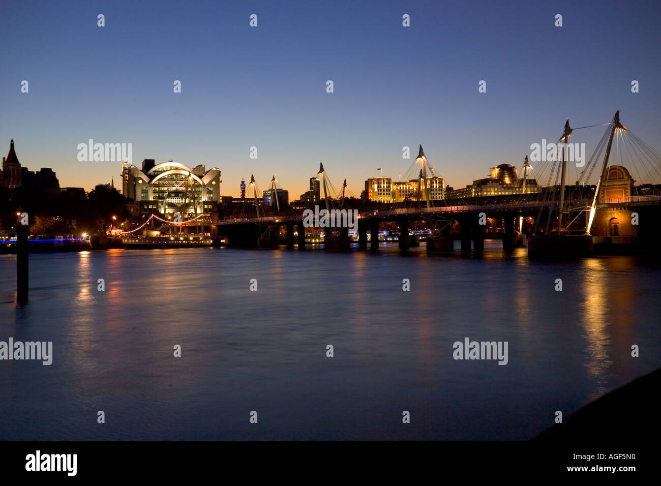 Hungerford bridge and Charing cross statin at night Stock Photo - Alamy