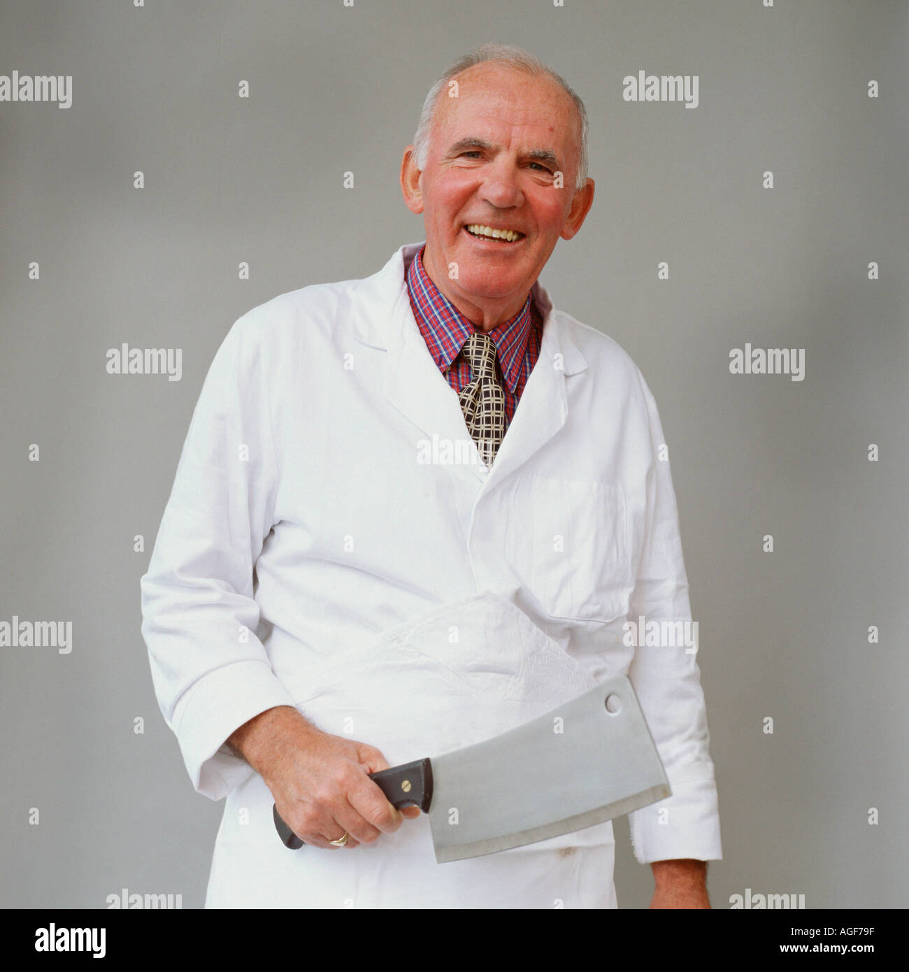 Smiling male butcher holding meat hi-res stock photography and images ...