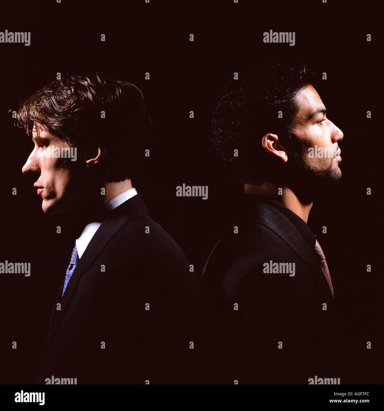 Businessmen back to back Stock Photo - Alamy