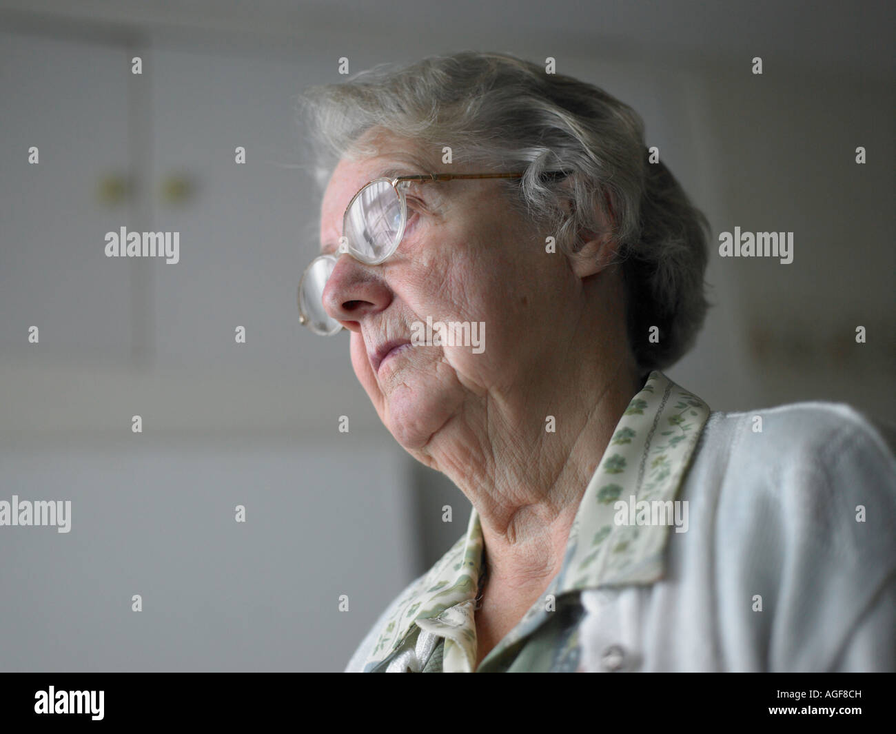 Old lady sat at window remembering Stock Photo - Alamy
