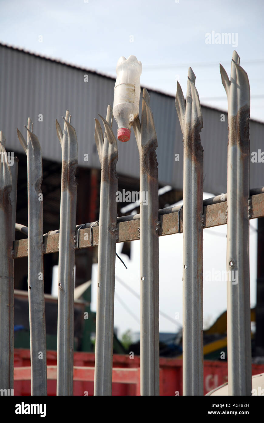 Bottle on fence Stock Photo - Alamy