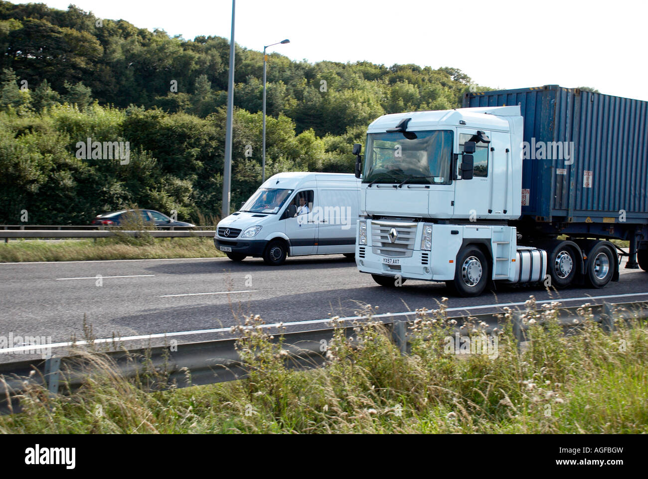 white van overtaking a lorry Stock Photo - Alamy