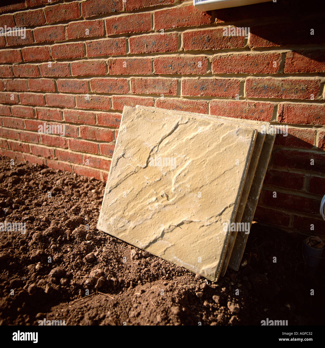 Slabs leaning against a brick wall Stock Photo - Alamy