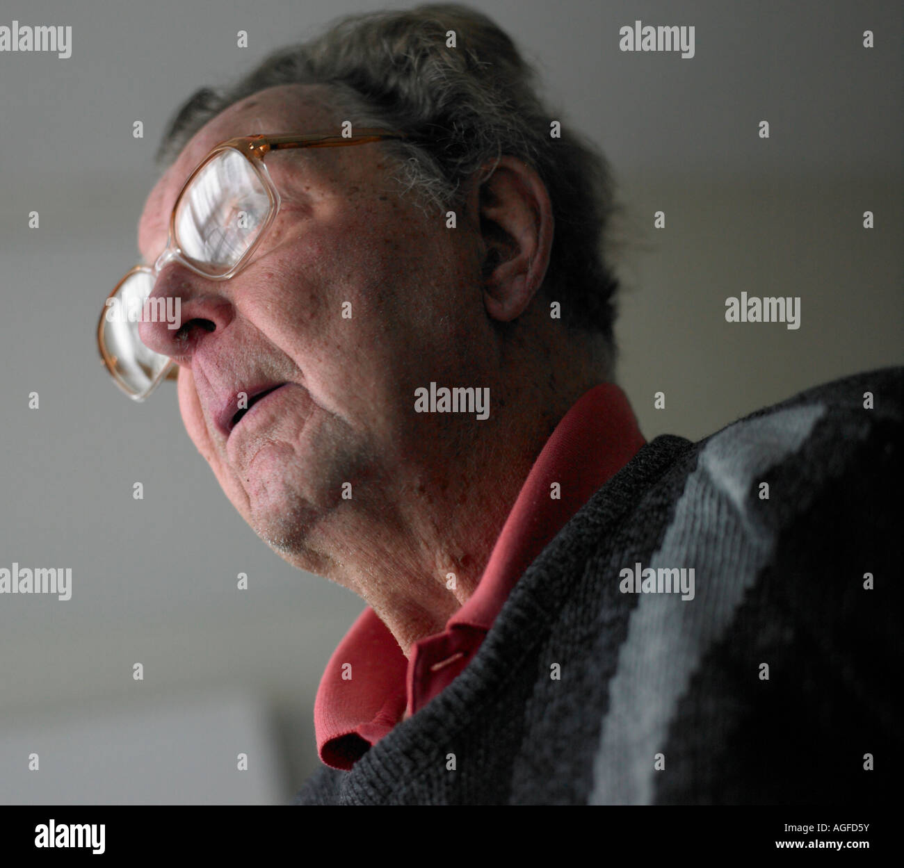 Old man sat at window thinking Stock Photo - Alamy