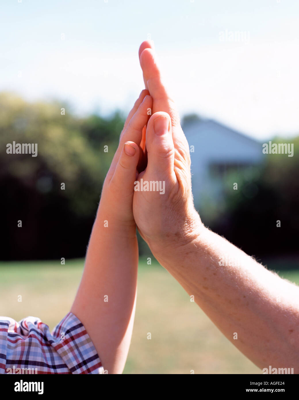 Hand of man and boy touching Stock Photo - Alamy