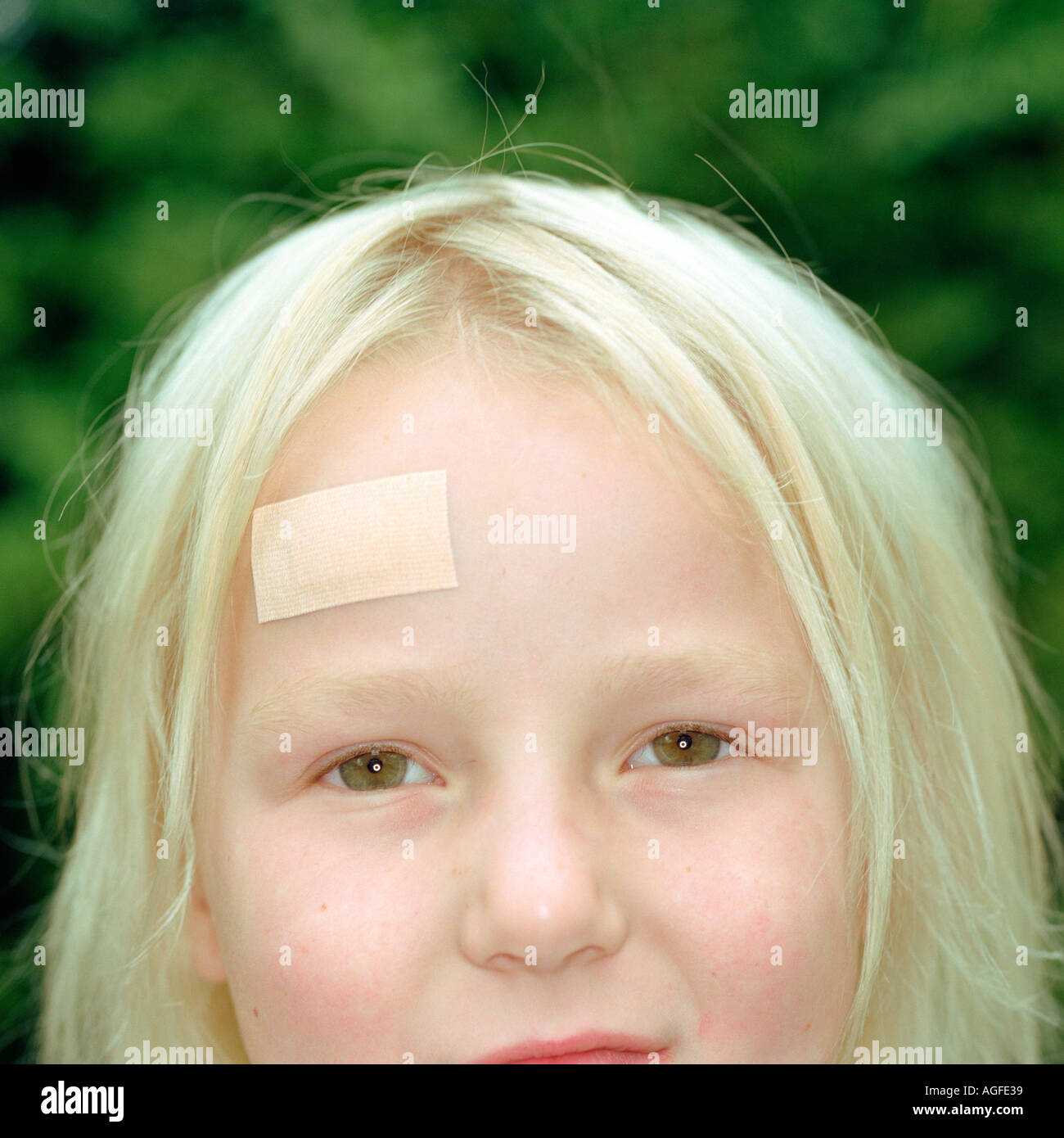 Girl with plaster on her forehead Stock Photo - Alamy