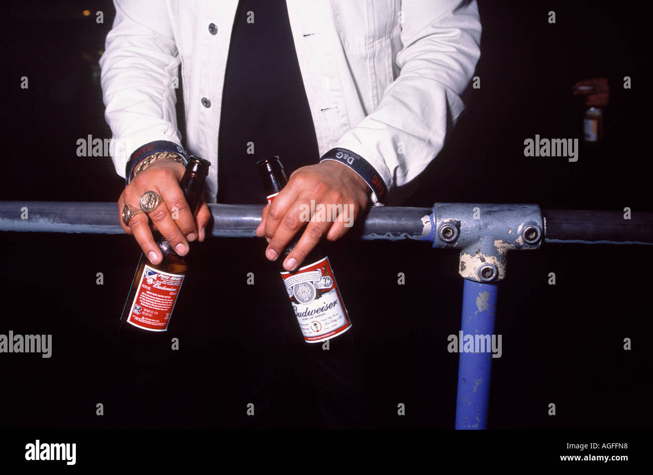 Close up of hands holding Budweiser bottles Stock Photo - Alamy