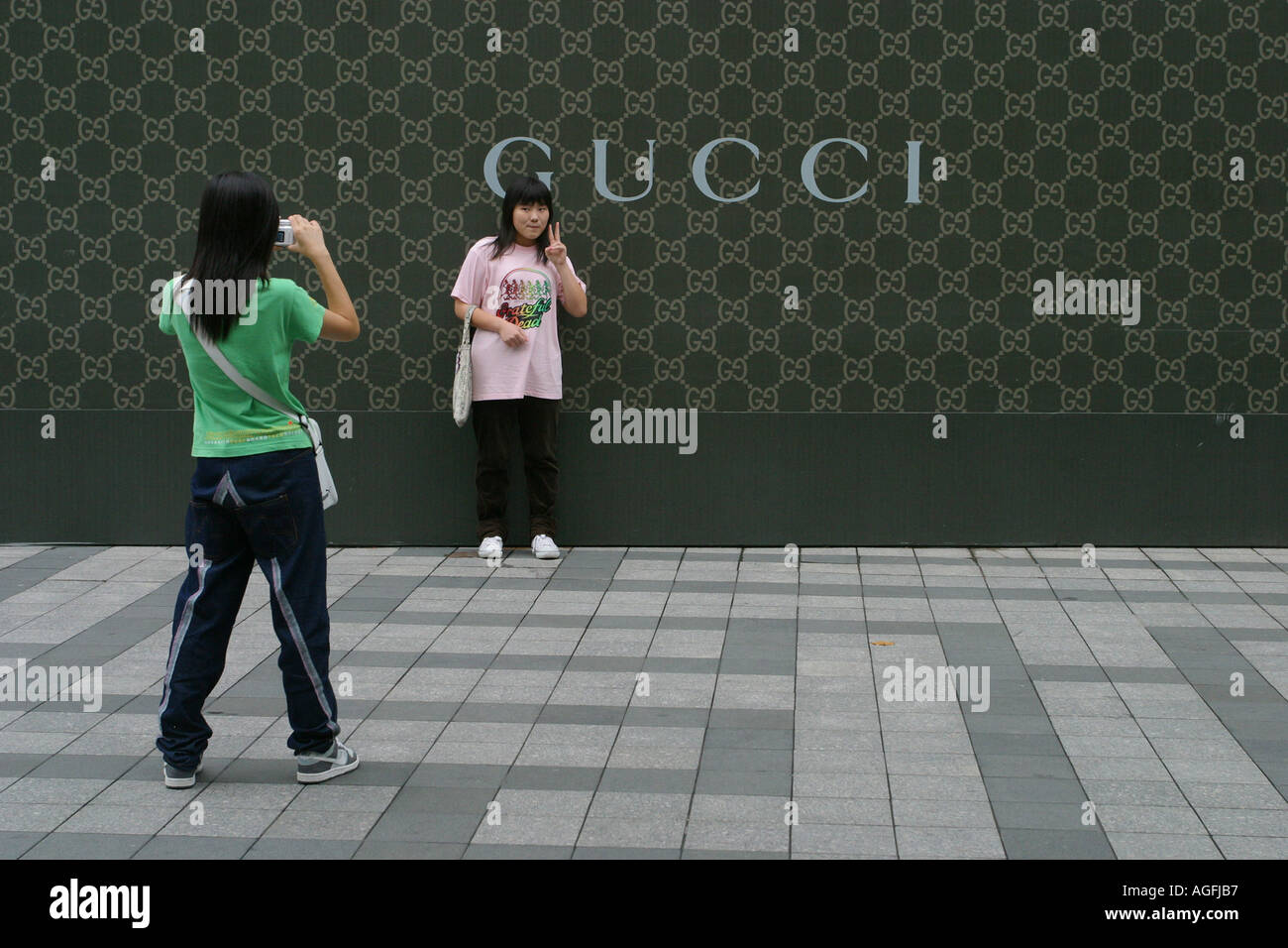 Girl posing outside a Gucci store Shanghai China Stock Photo - Alamy