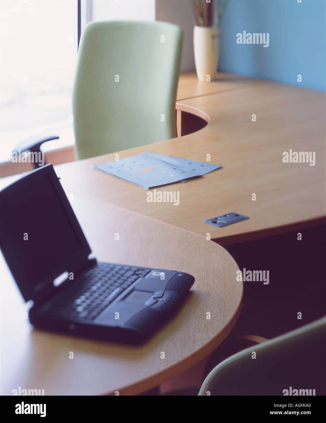 A modern office scene with managers chair desk and laptop Stock Photo ...