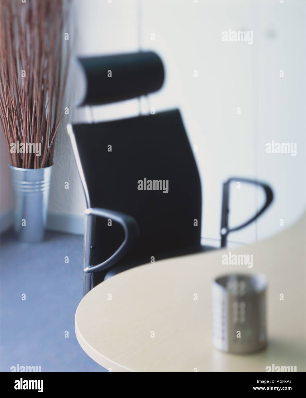 A modern office scene with a black managers chair and desk nice natural ...