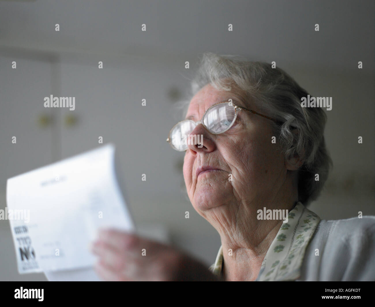 Old lady reading bill Stock Photo - Alamy