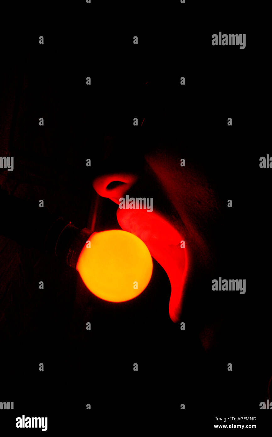 Teenager eating a glowing bulb Stock Photo - Alamy