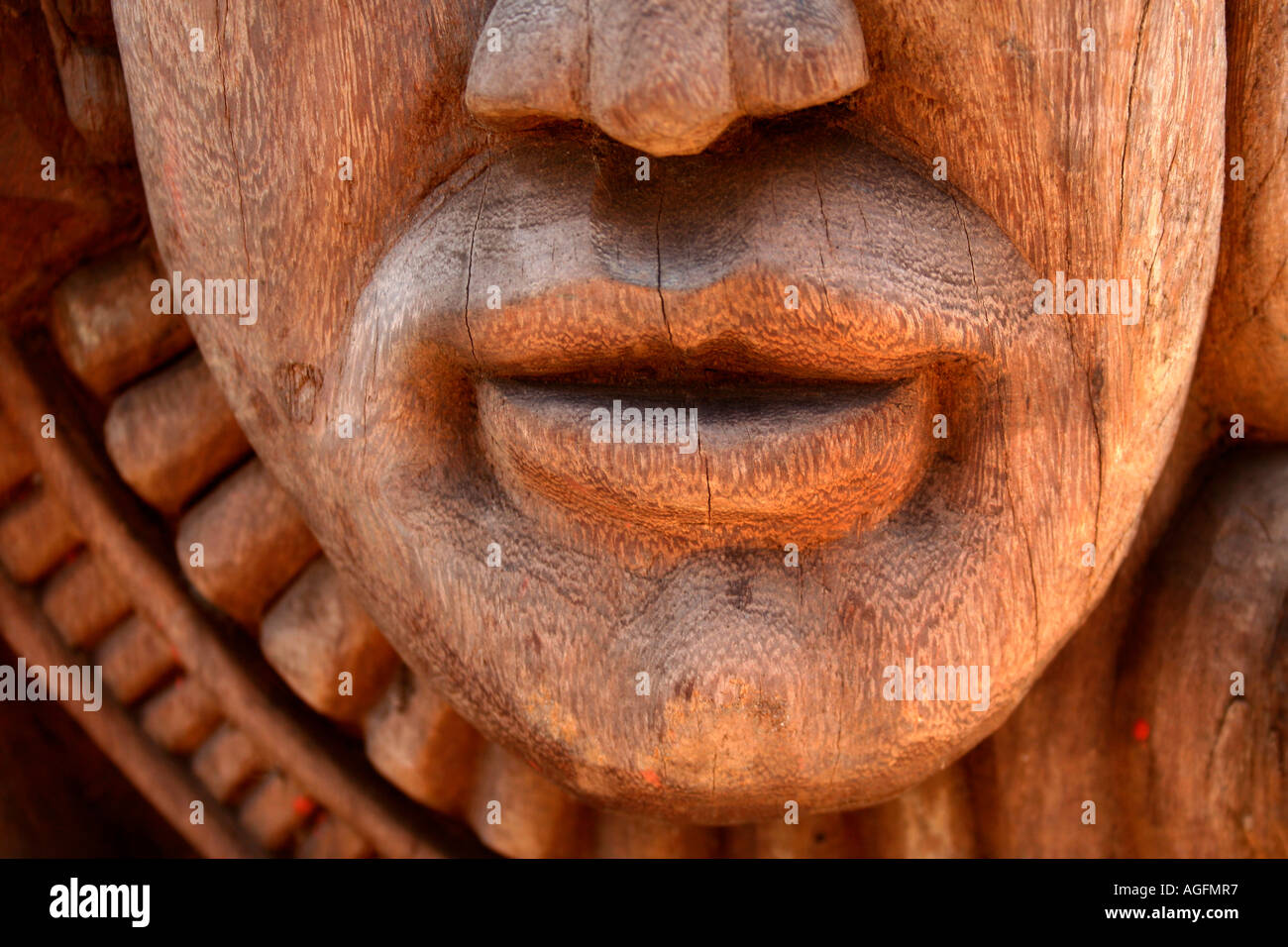 Close up of the lower part of face of a wooden statue of an African ...