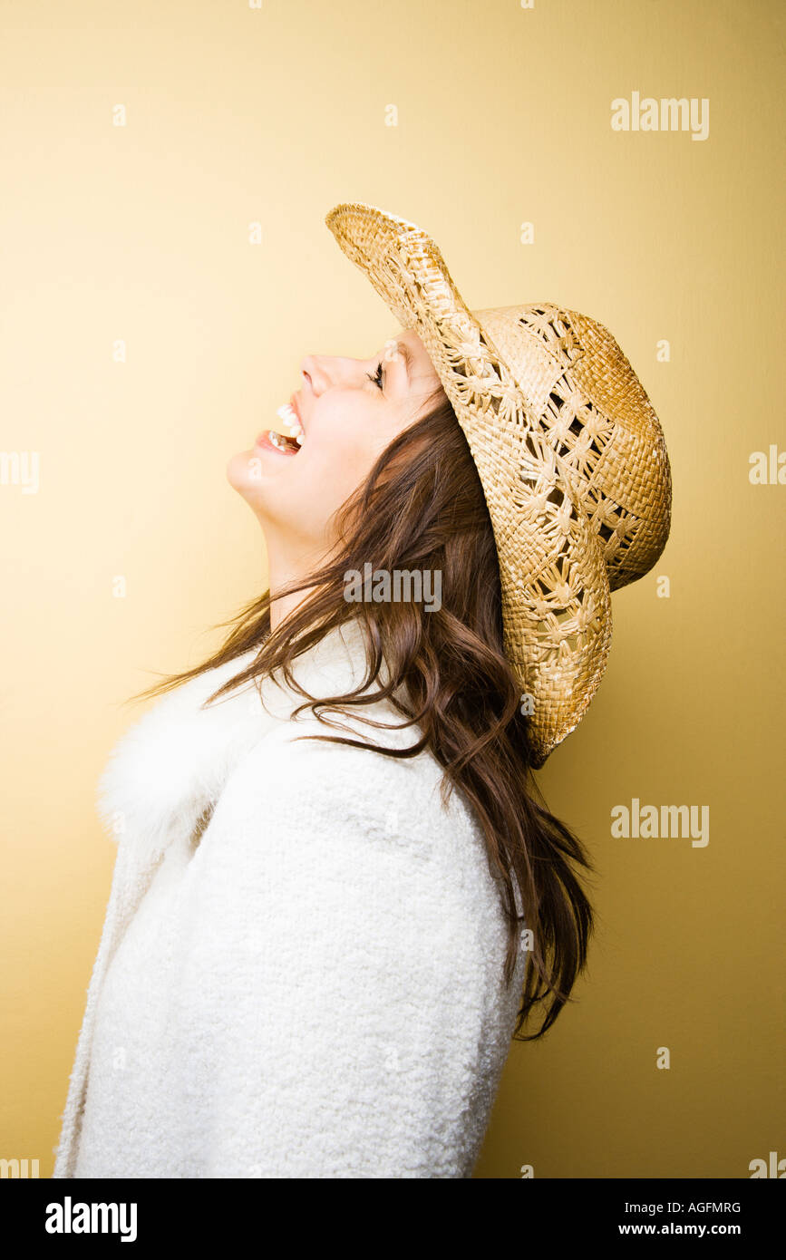 Profile of young adult Caucasian woman wearing cowboy hat leaning ...