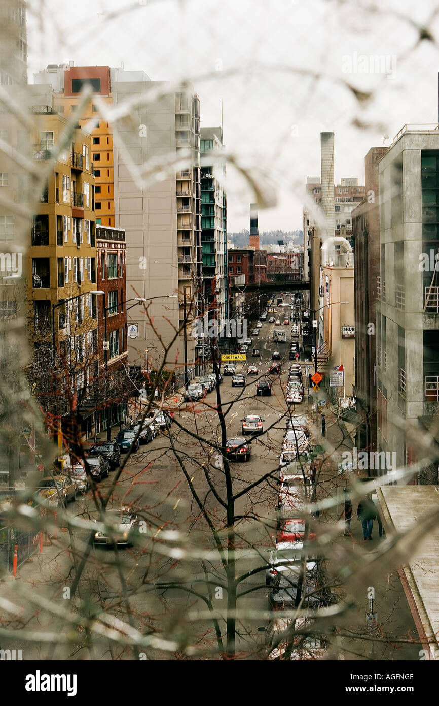 Photo of a busy city street seen through a whole broken out of a window ...