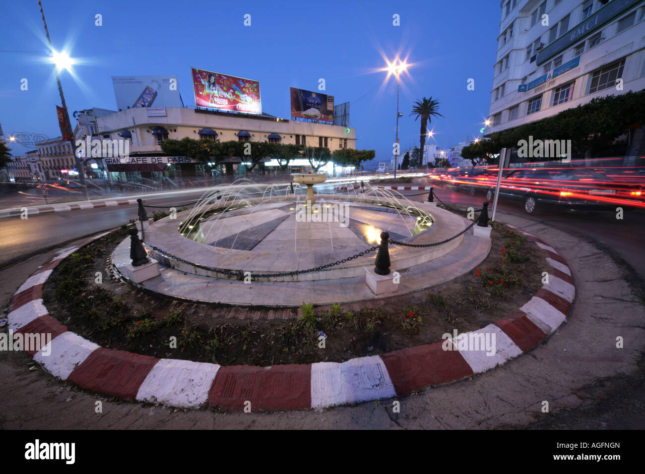 Roundabout with fountain in central Tangier at dusk Stock Photo - Alamy
