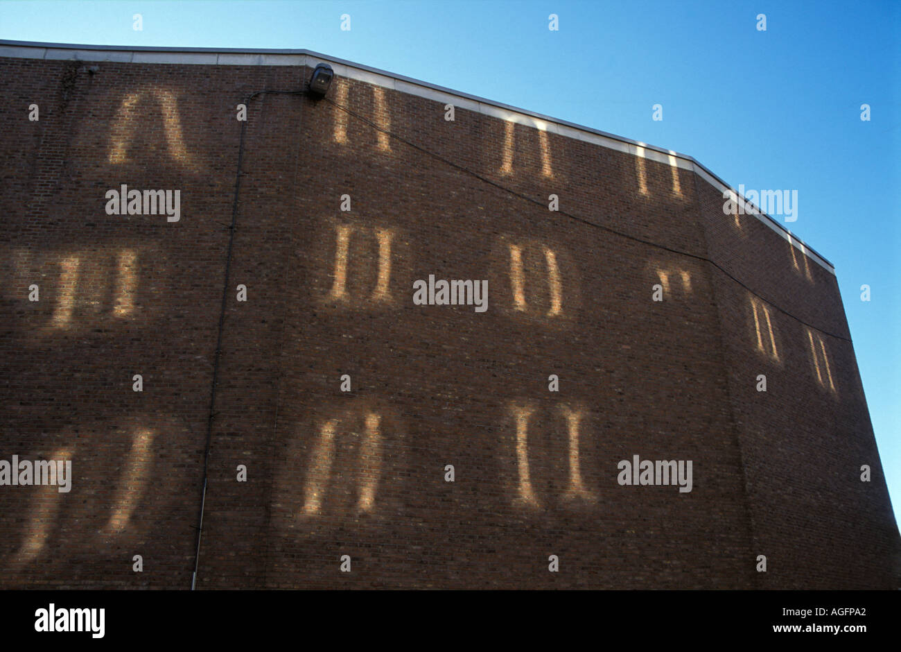 Light reflecting from windows from opposite building on wall Stock ...