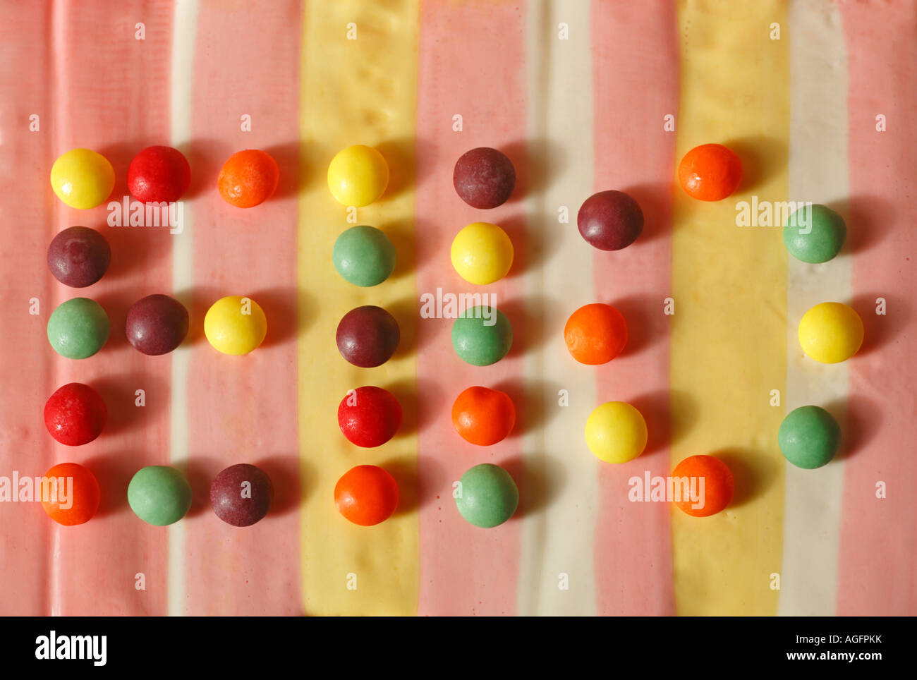 Coloured sweets spelling E110 Stock Photo - Alamy