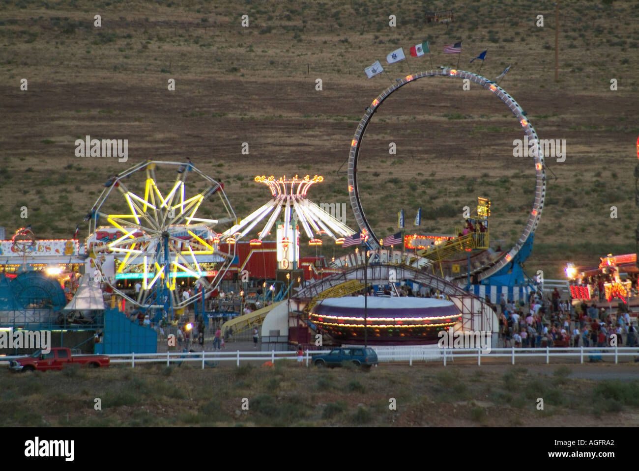 The carnival rides light up on the desert at the Washington County Fair ...