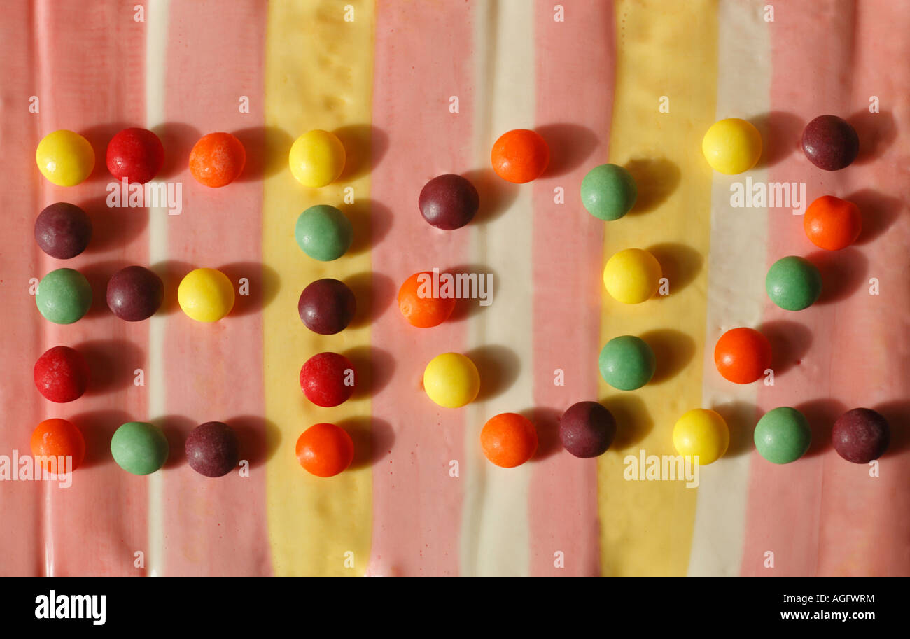Coloured sweets spelling E102 Stock Photo - Alamy