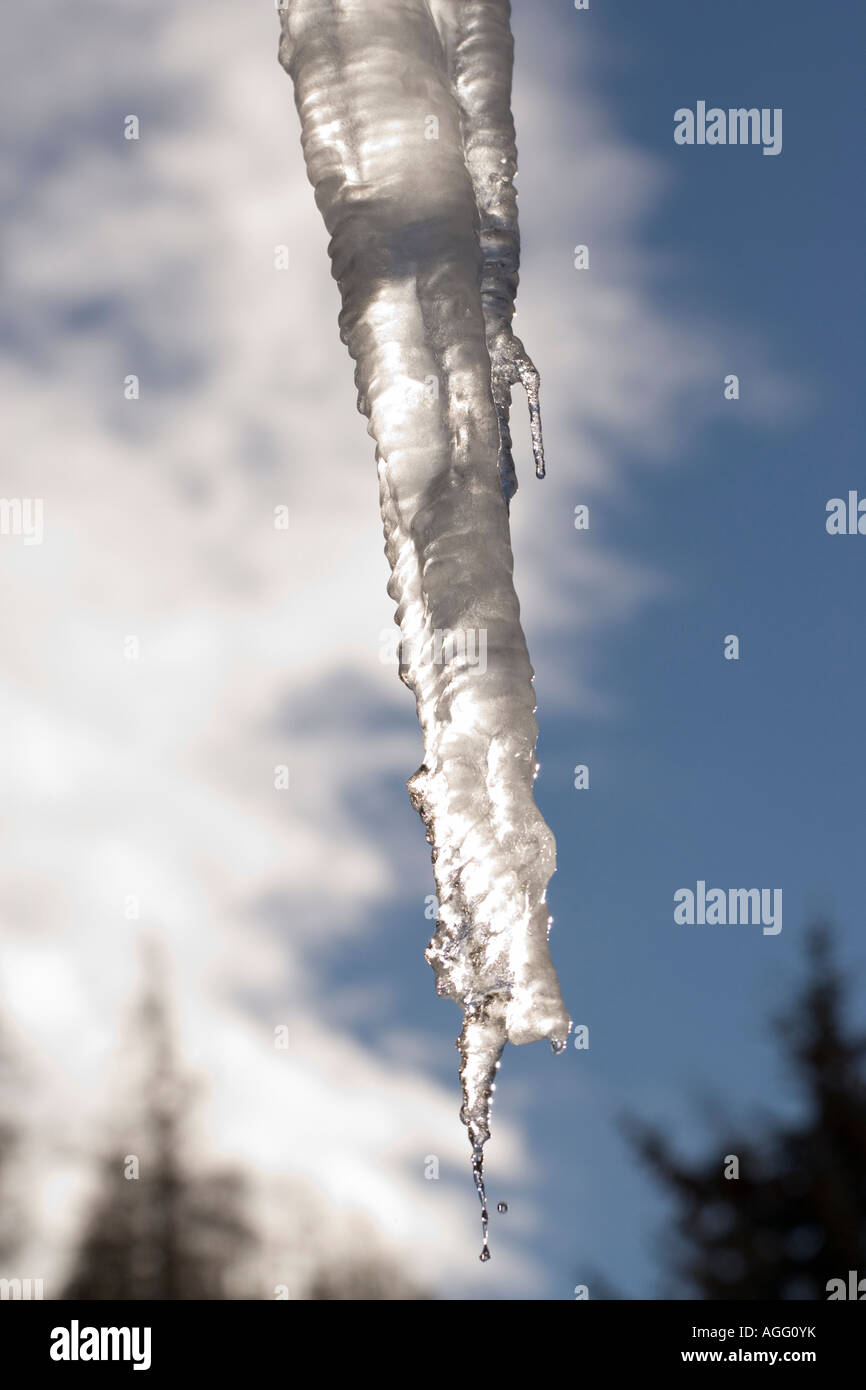 Big Icicle hanging from a roof against the blue sky, Ice Stock Photo ...