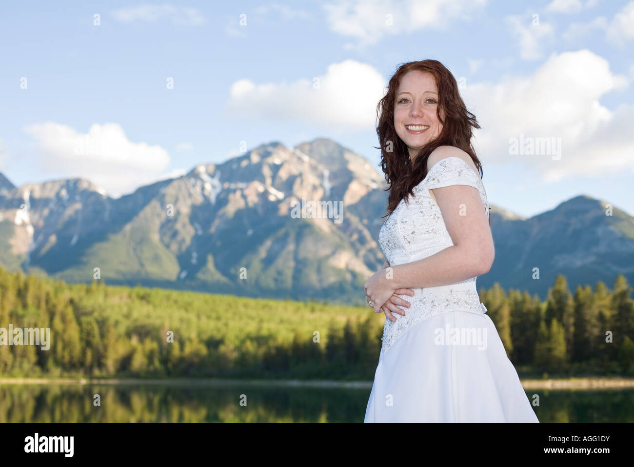 A newlywed bride poses for a portrait in Patricia Lake, Jasper National ...