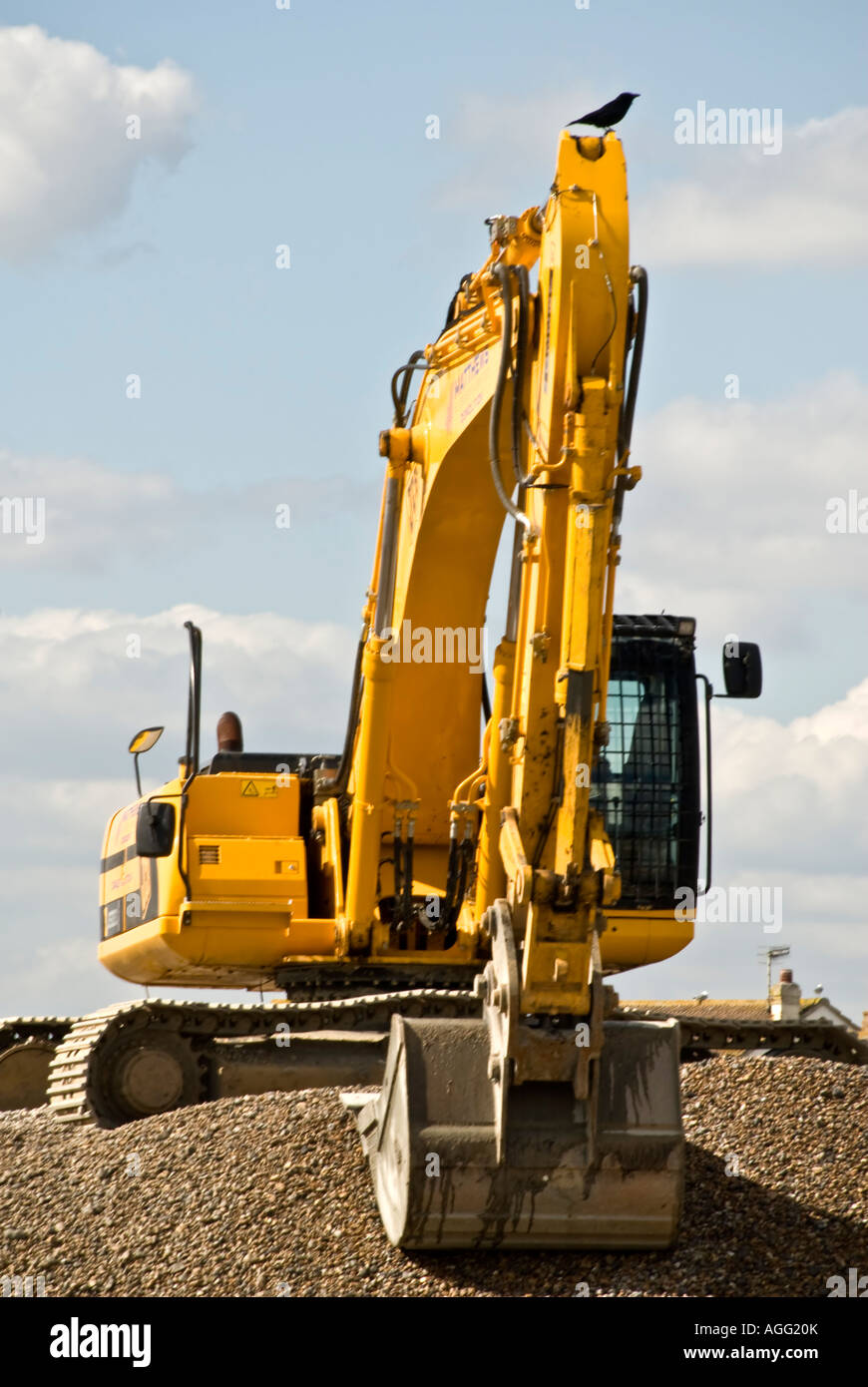 YELLOW EXCAVATOR MOVING SHINGLE WORKING ON THE BEACH "Power shovel ...