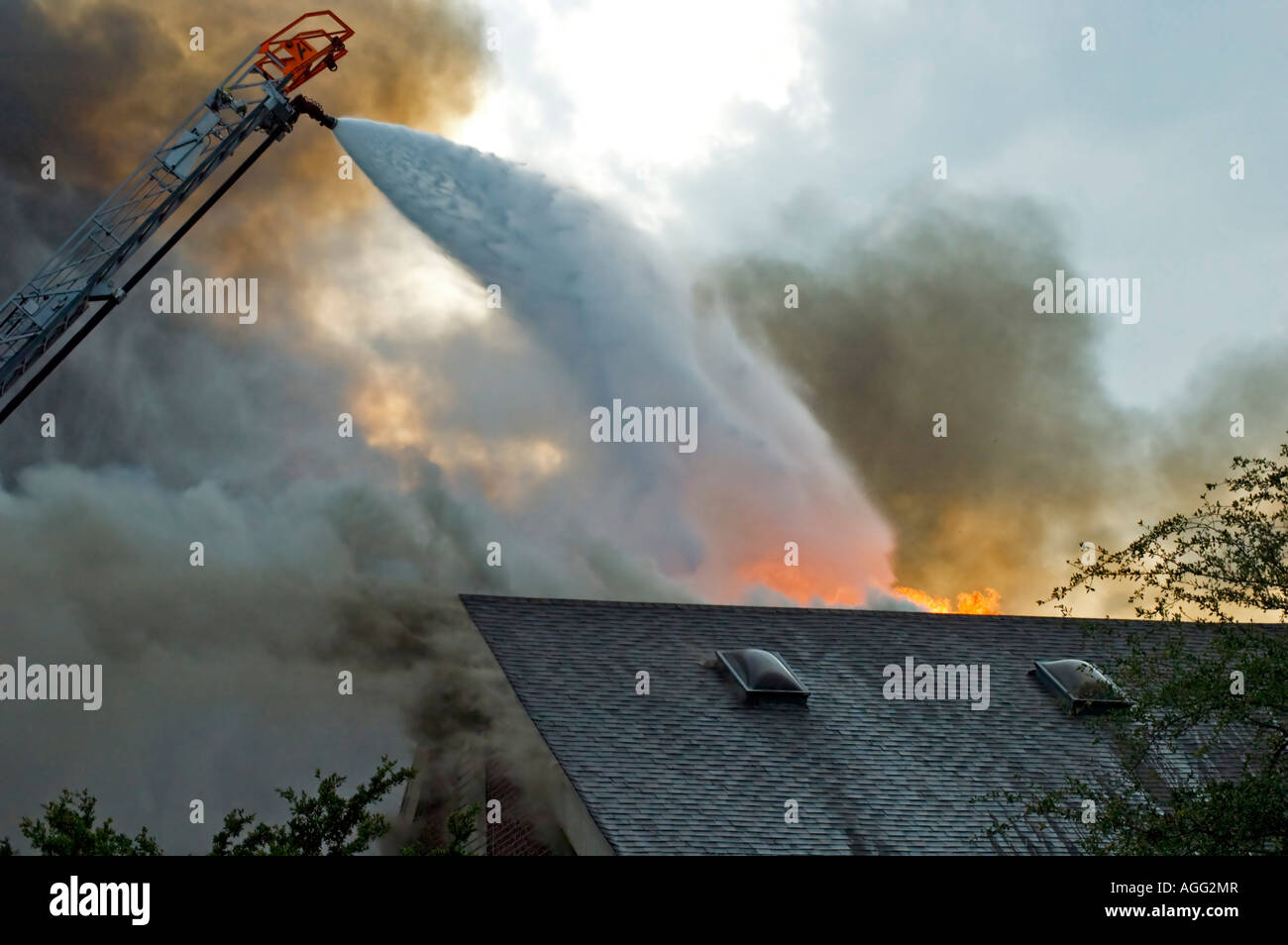 Hose putting water on structure fire Stock Photo - Alamy