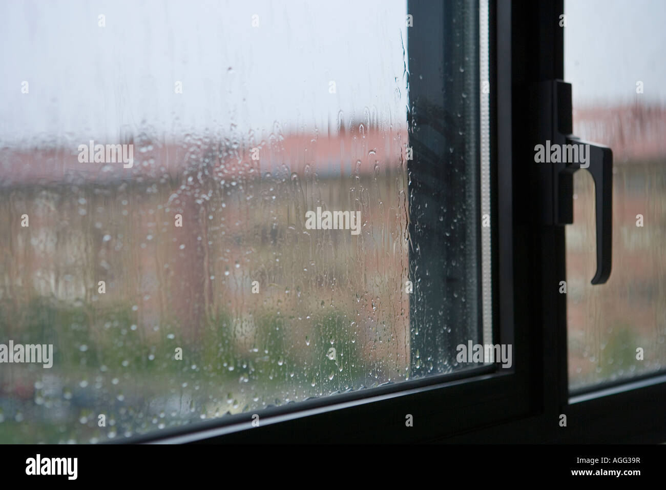 Wet window looks out on the working class district under a rainstorm ...