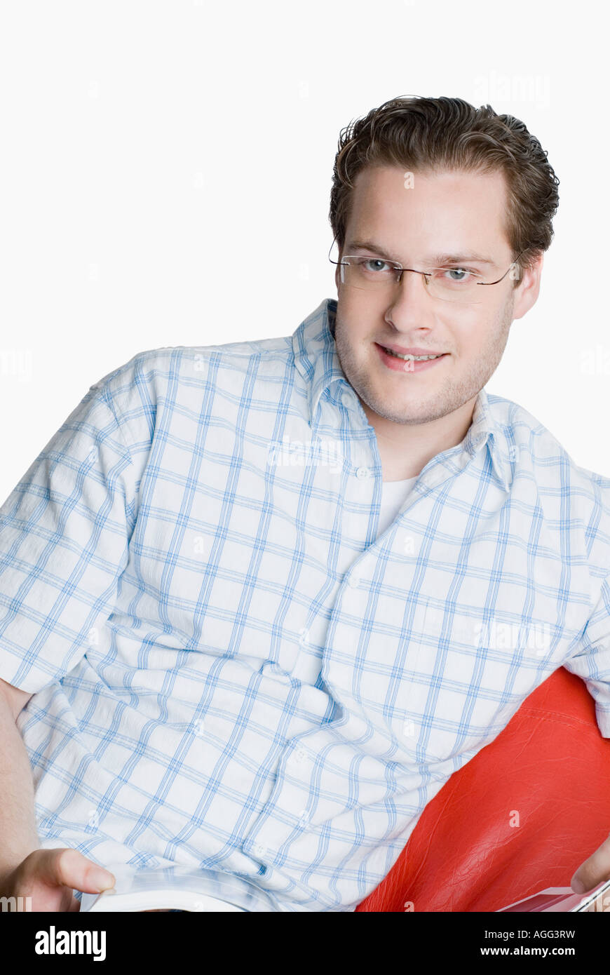 Portrait of a young man holding a magazine and smiling Stock Photo - Alamy