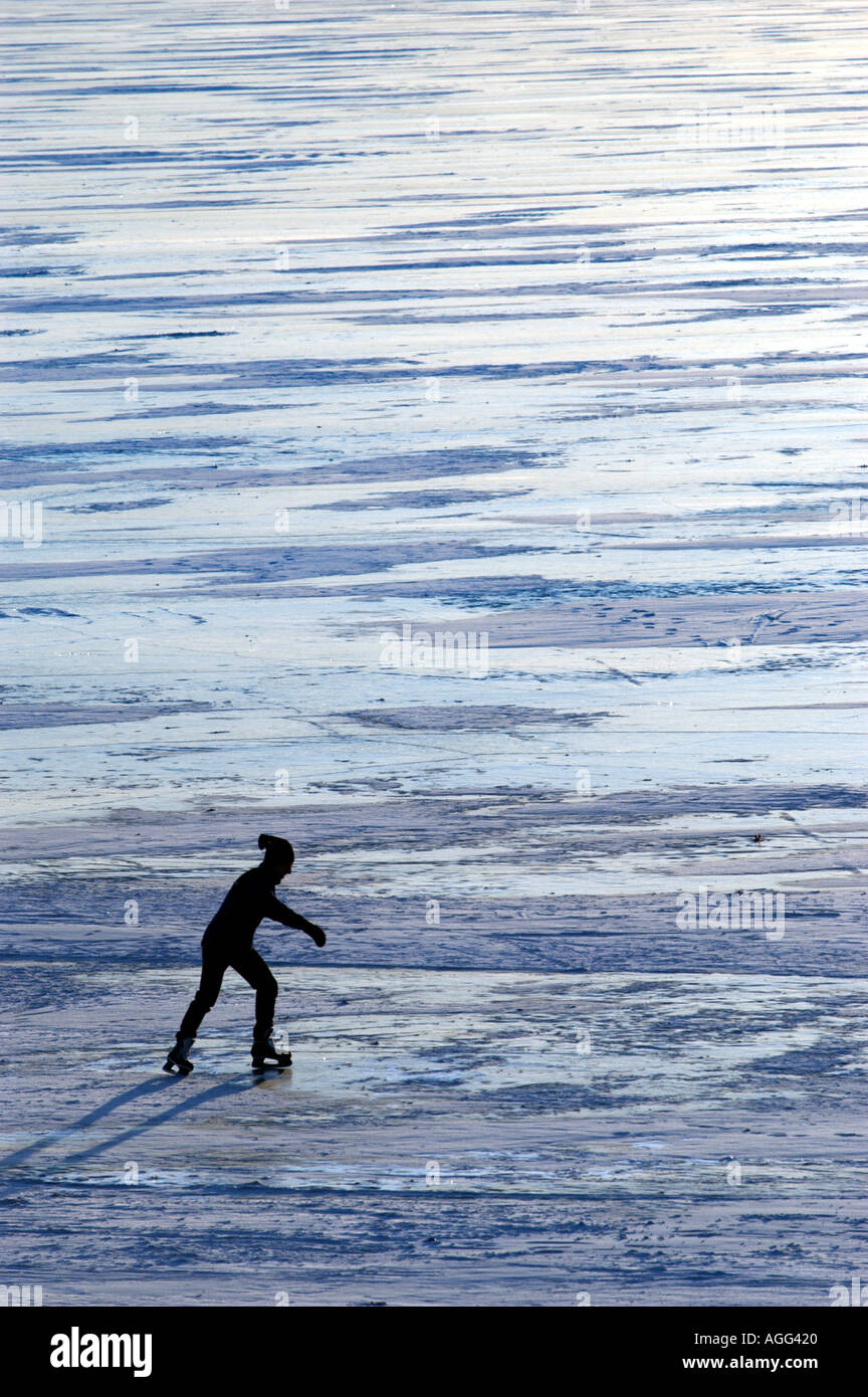 A lone skater fights his way across the rough surface of Lake Calhoun ...