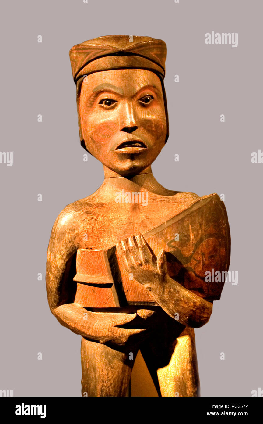 Figure of a famous Kwakiuti chief holding a ceremonial copper plate ...