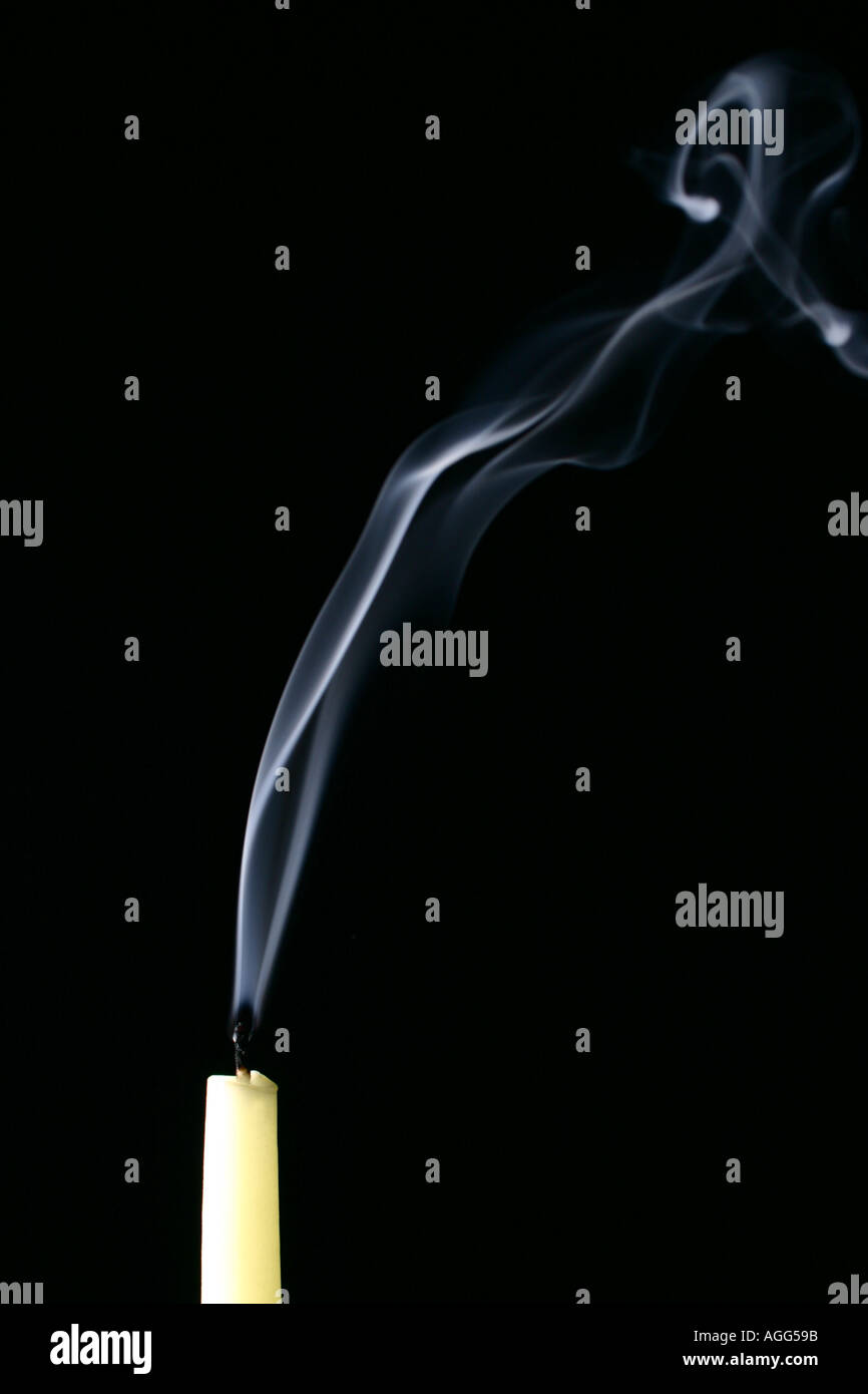 smoking extinguished candle against black background Stock Photo - Alamy