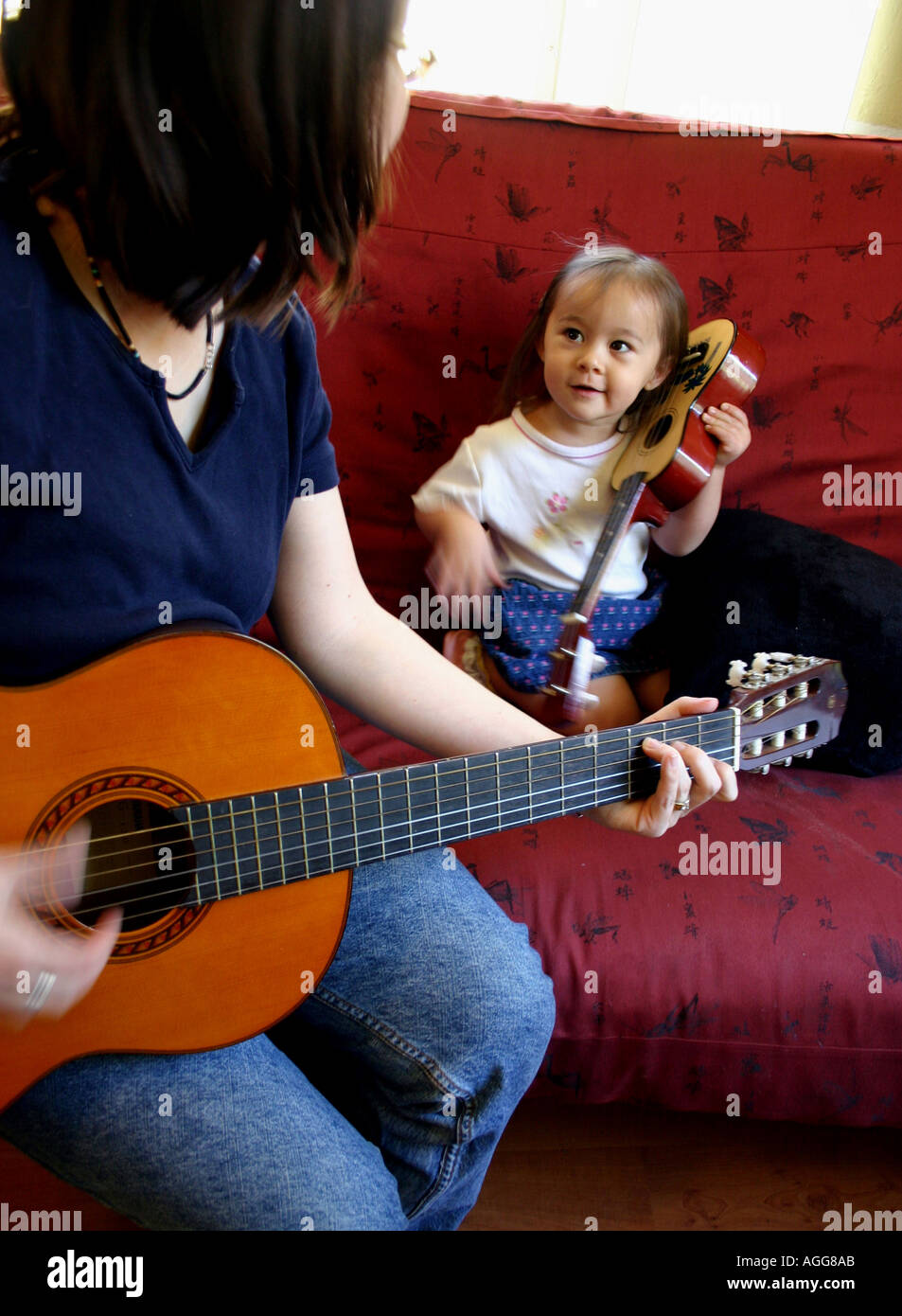parent and child playing music together at home Stock Photo - Alamy