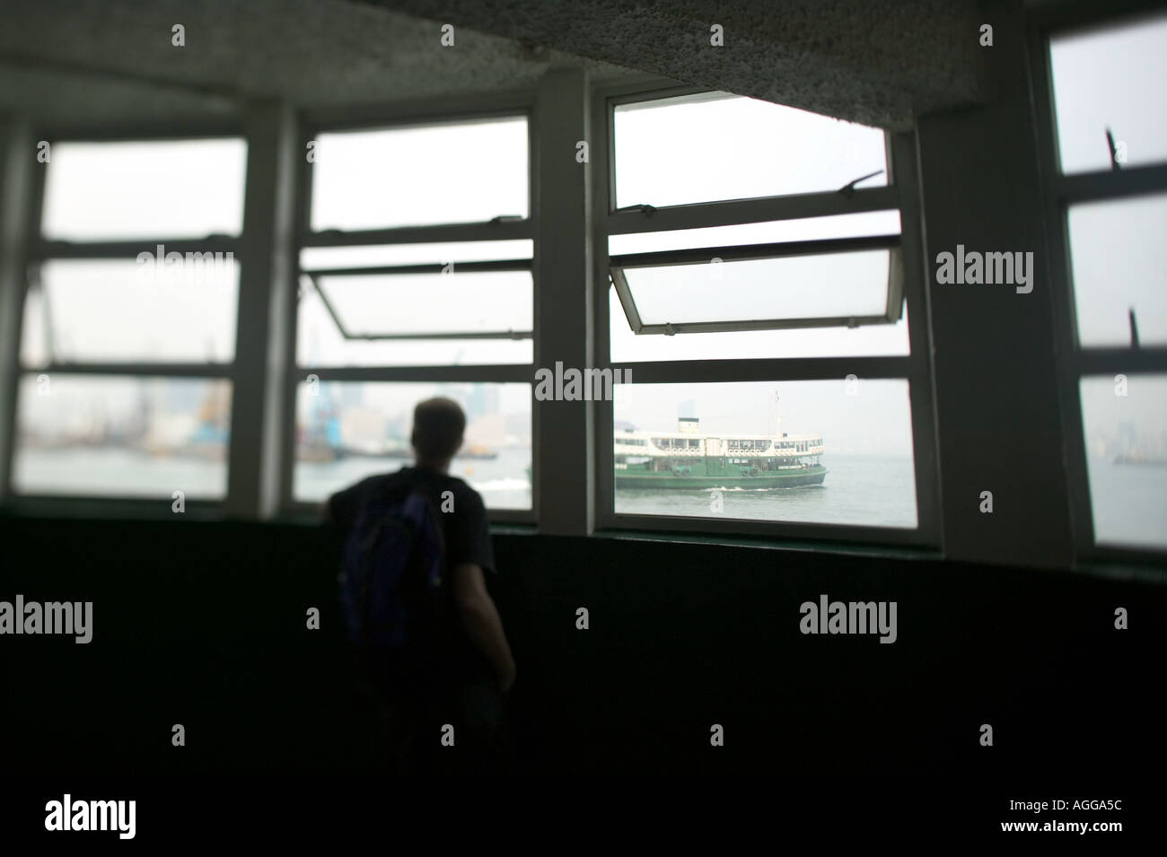 Tourist looks through window at Star Ferry in Hong Kong Harbour Stock ...